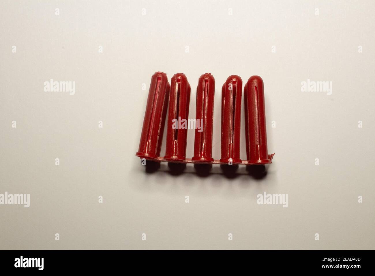 cluster of red wall plugs isolated on a plain white background Stock ...