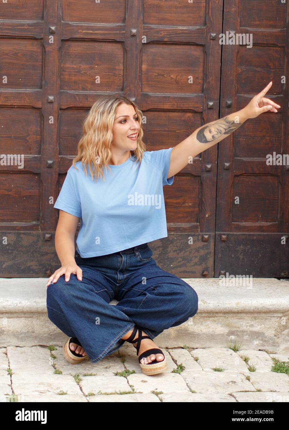 Young woman point with hand Stock Photo - Alamy