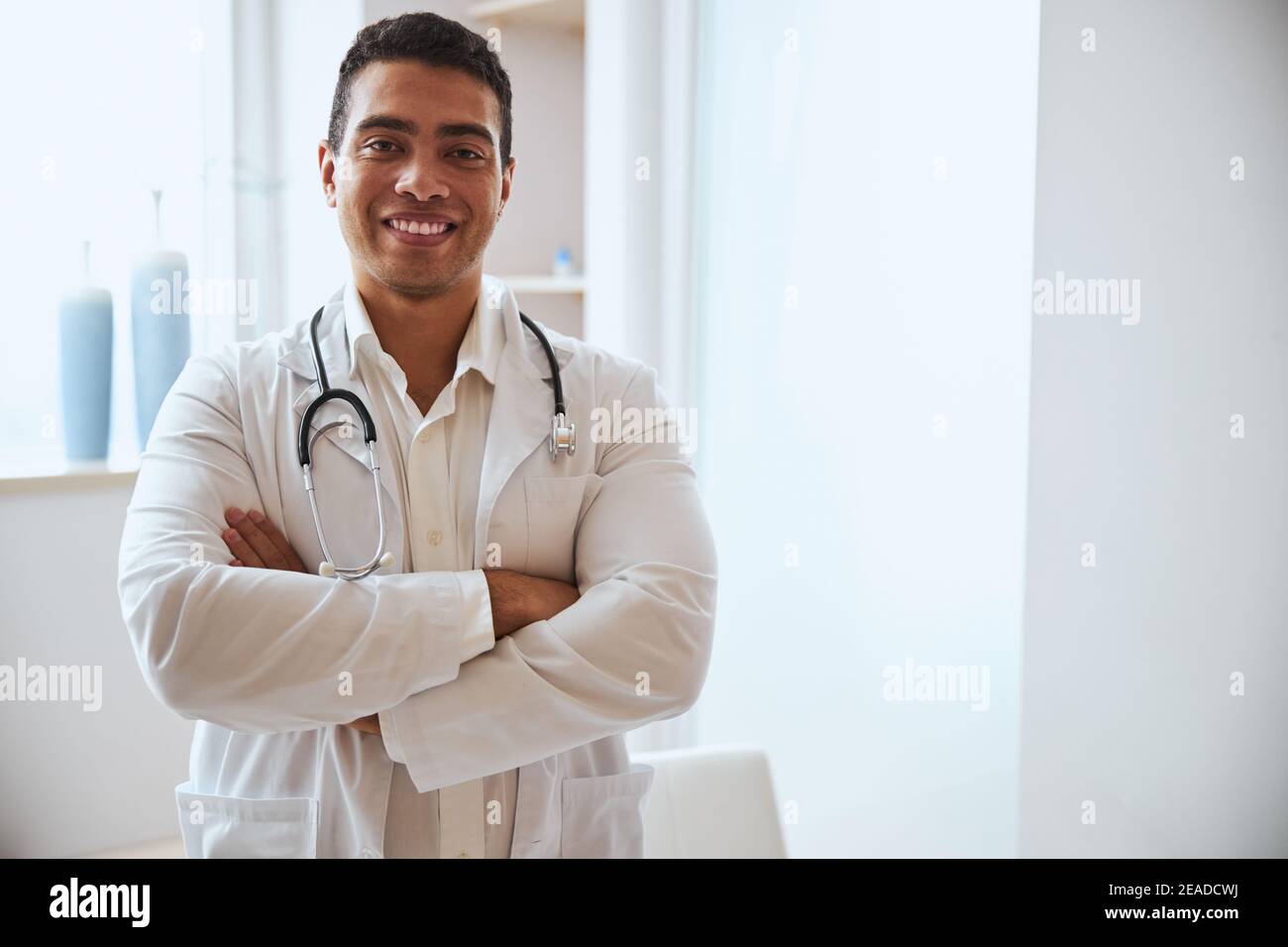 Happy smiling Indian young intern with stethoscope posing at the photo ...