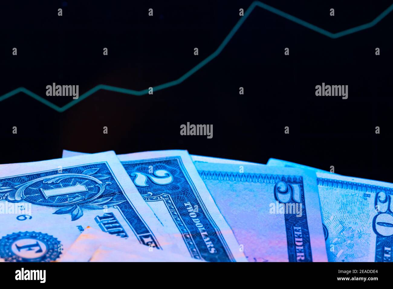 American dollar banknotes and graph on black background Stock Photo - Alamy