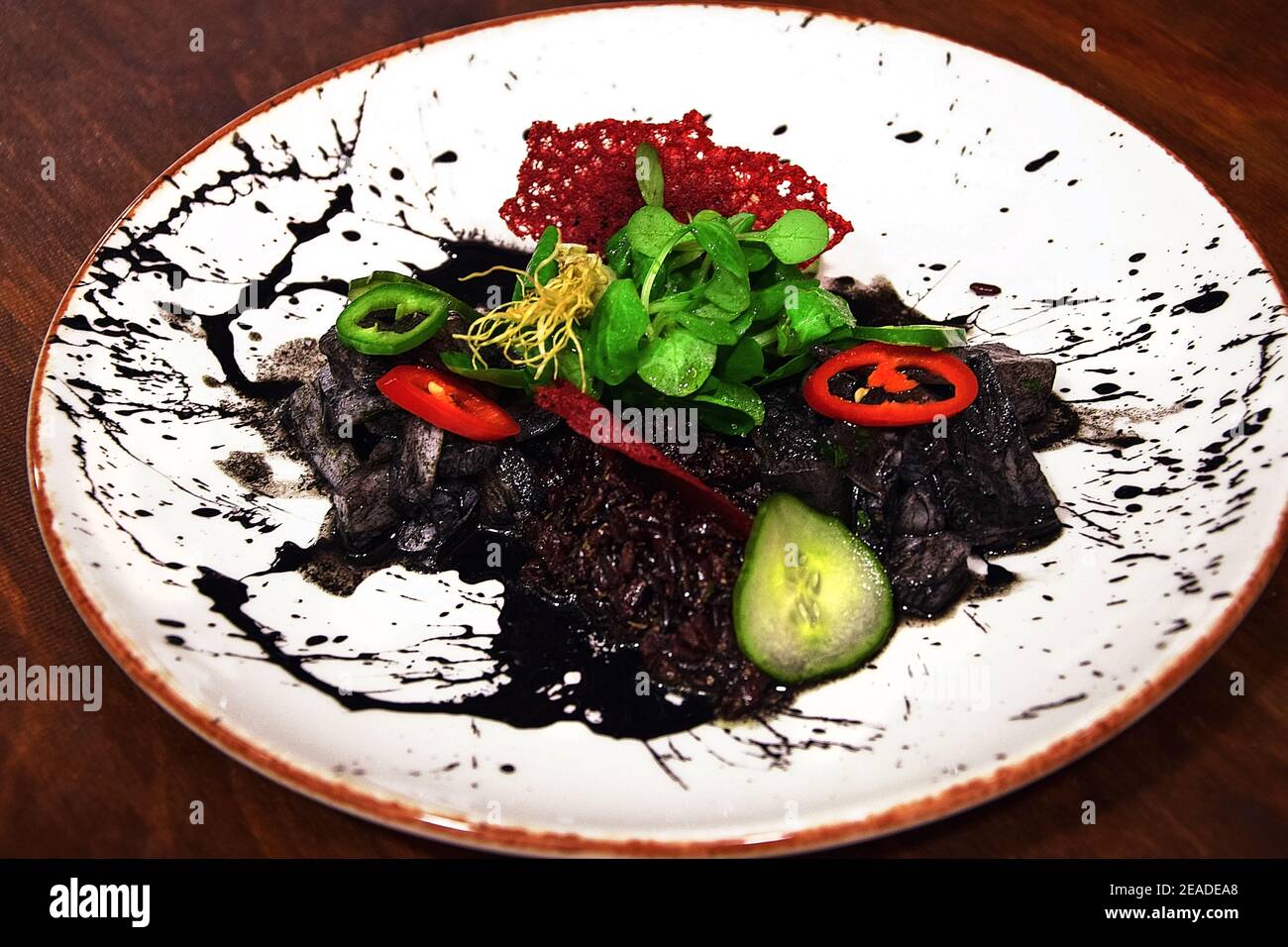 Ceviche seabass, with perfumed black rice on cuttlefish ink Stock Photo ...