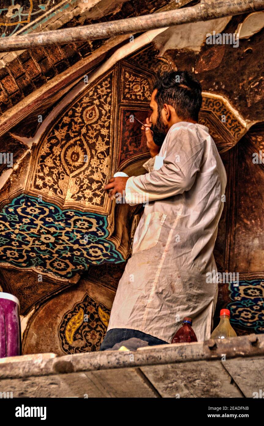 Restorer working on the restoration of the decorations of the bazaar ...