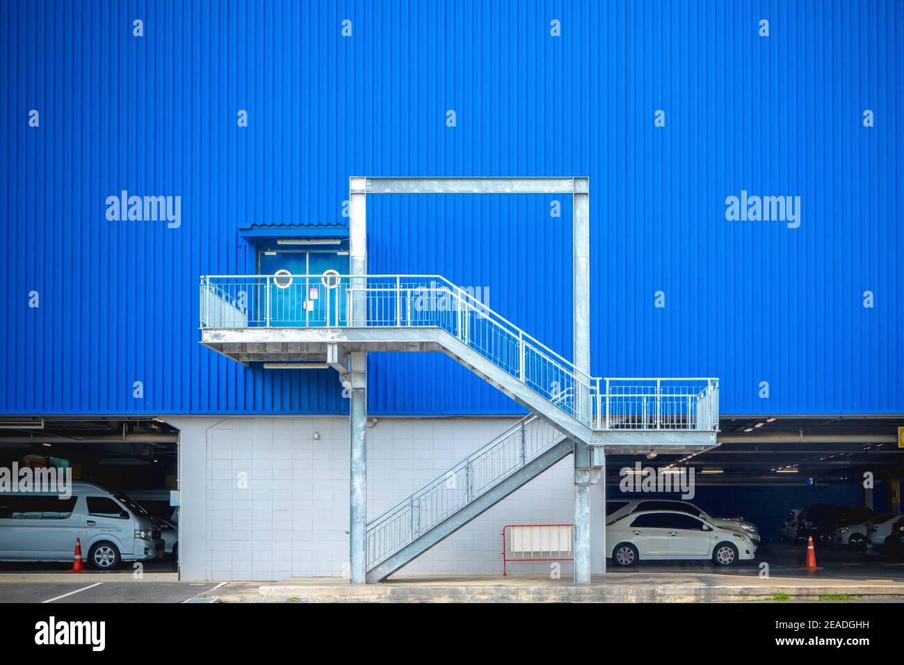 Outdoor fire escape blue metal wall building background Stock Photo - Alamy
