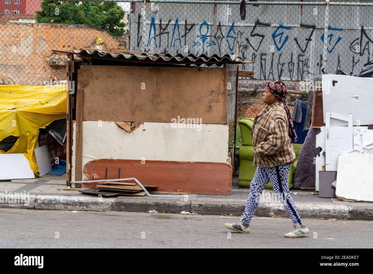 A long narrow street of makeshift homes and open-air drug market is ...