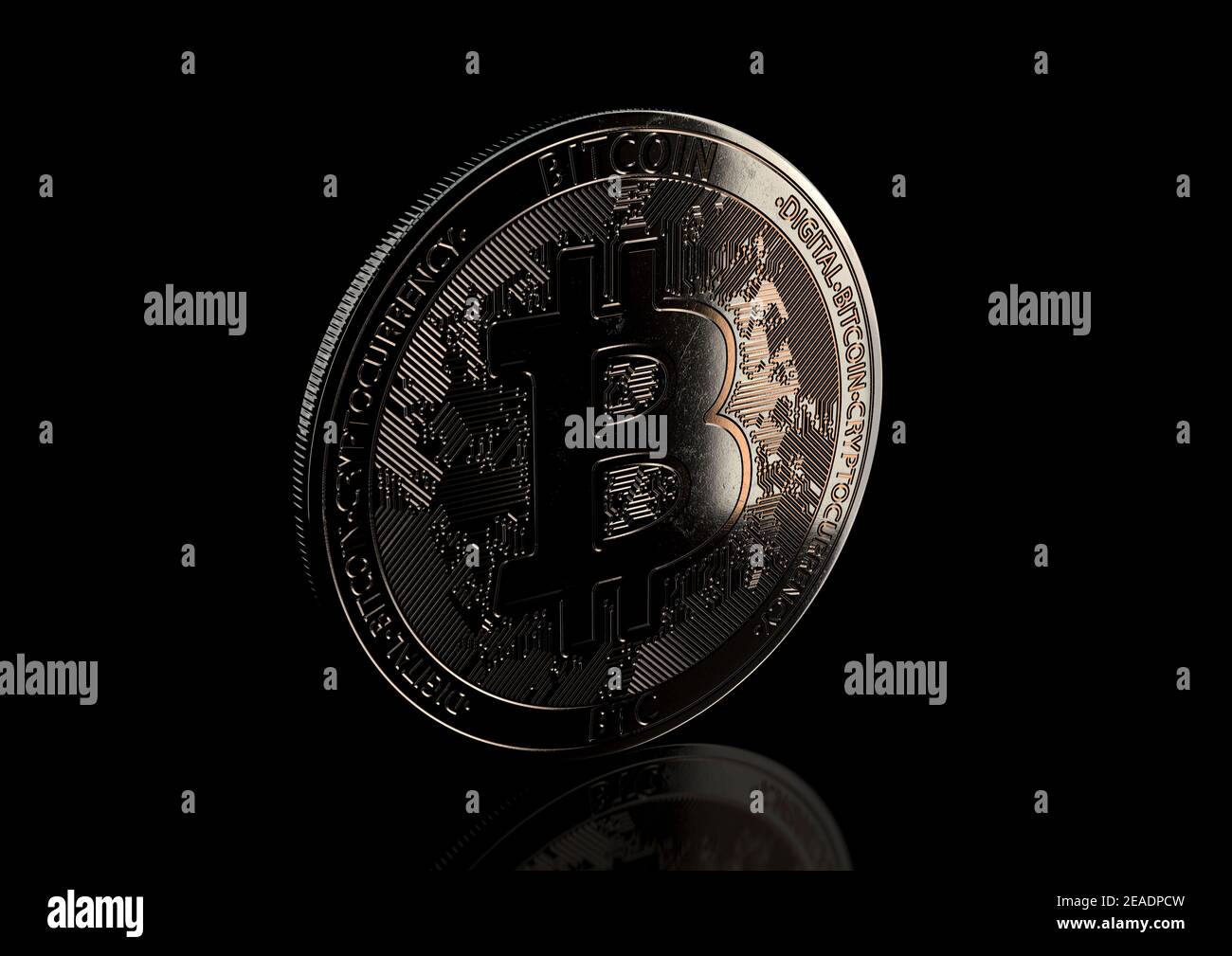 A dimly lit physical Bitcoin cryptocurrency in bronze and silver coin ...