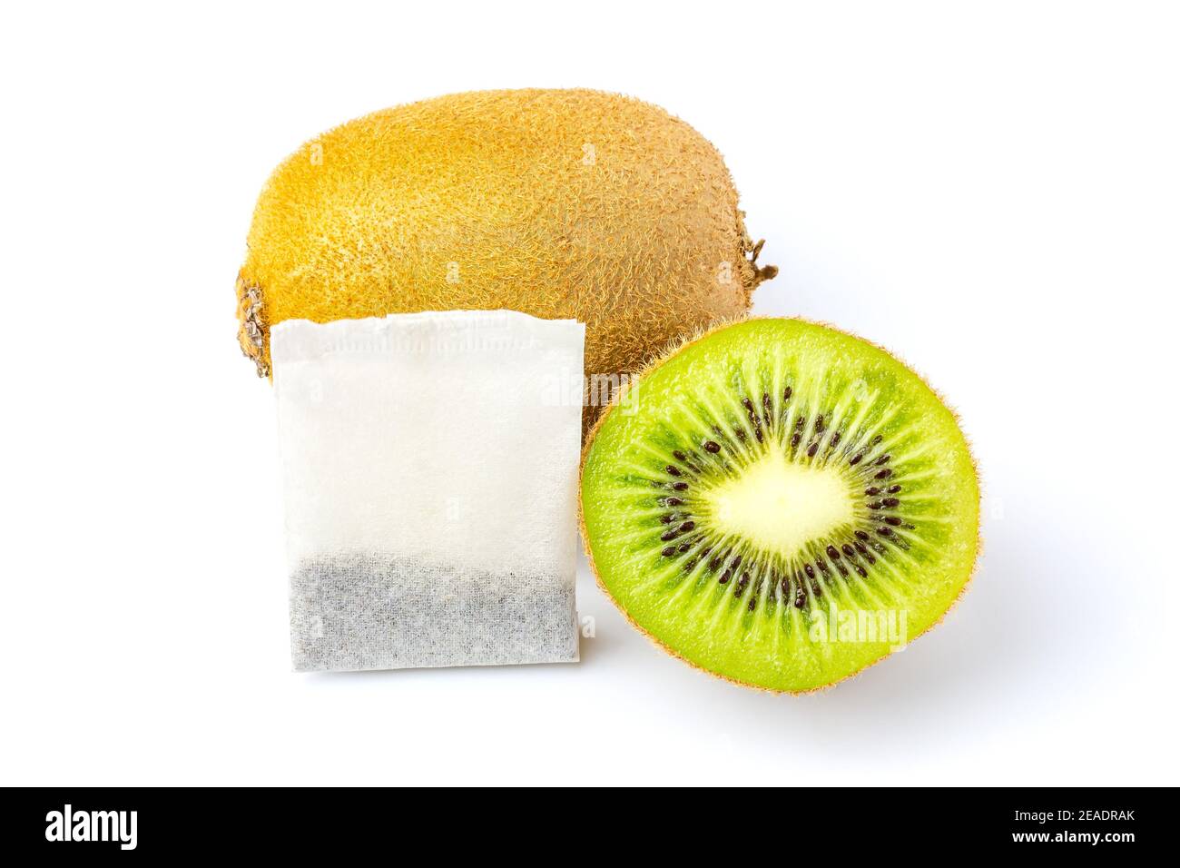 Tea bag with kiwi flavor. Tea bag and two kiwis, one in a cut isolated ...