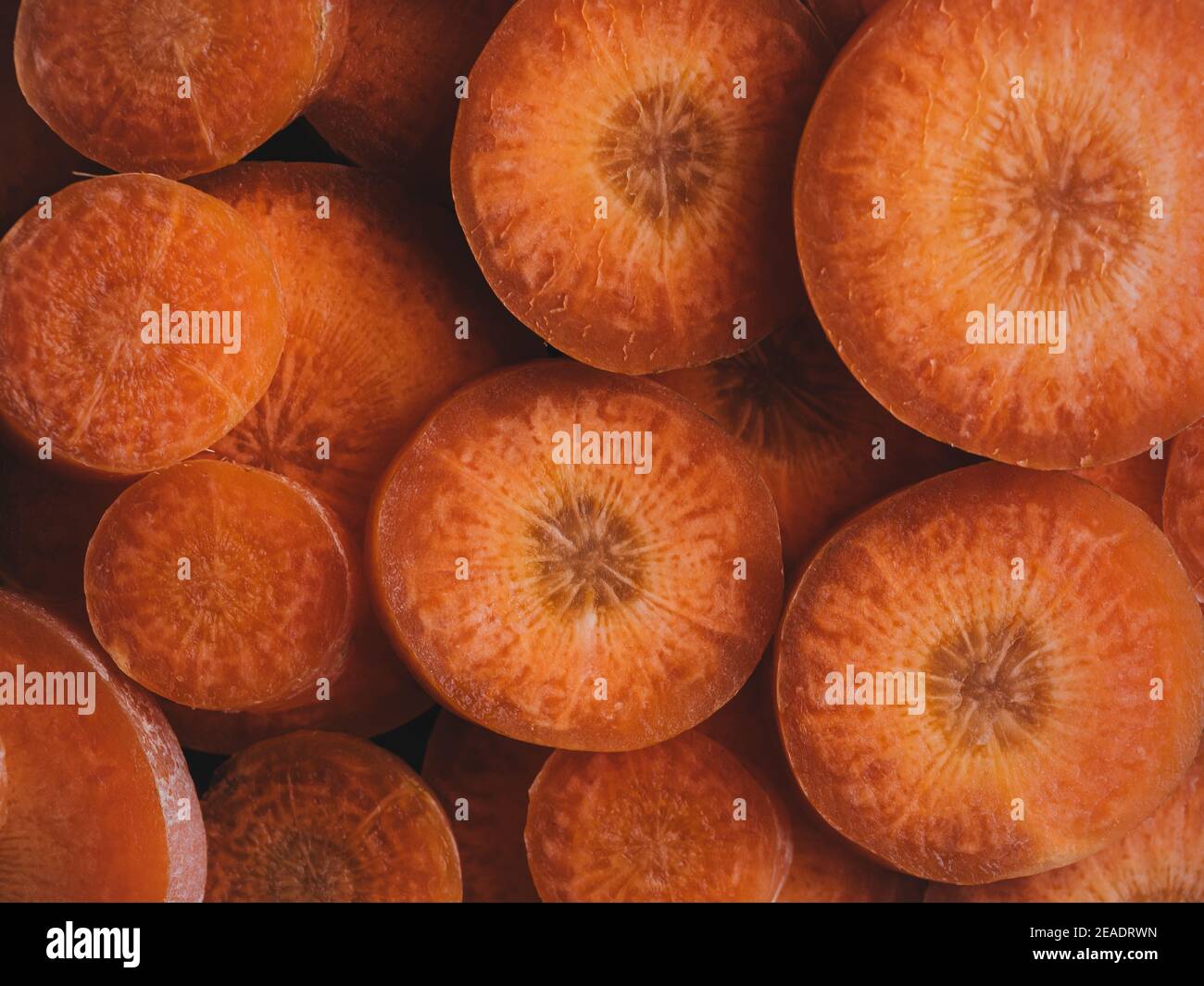 orange food background. close-up of circular sliced carrots. Bunch of ...