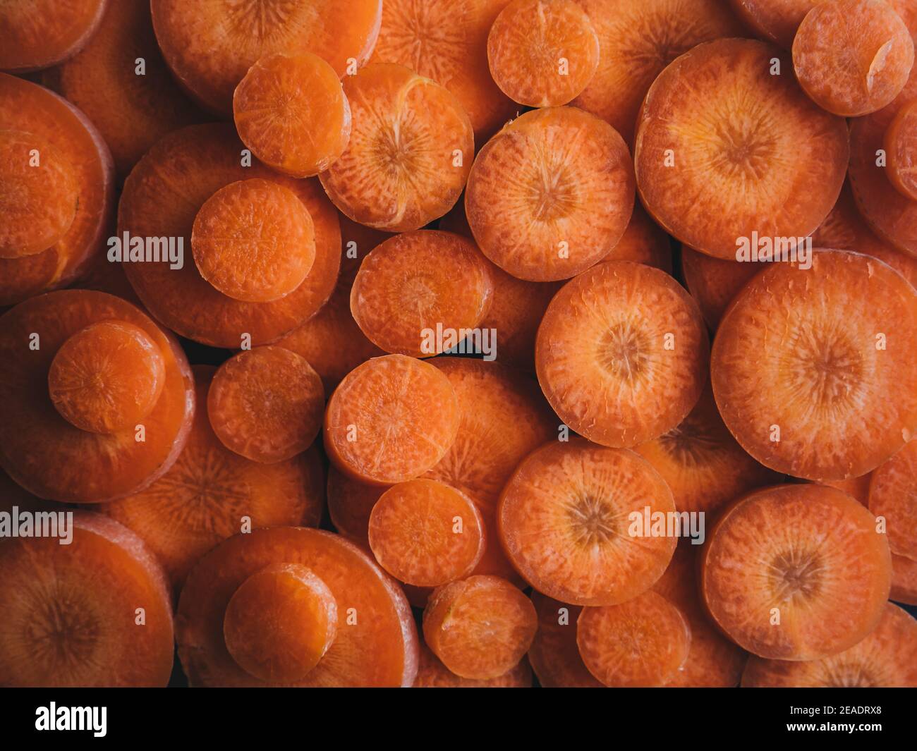 orange food background. close-up of circular sliced carrots. Bunch of ...