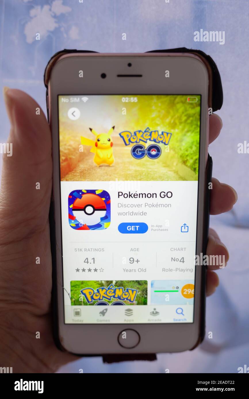 Close-up of a hand holding a mobile phone with Pokemon Go app on screen ...