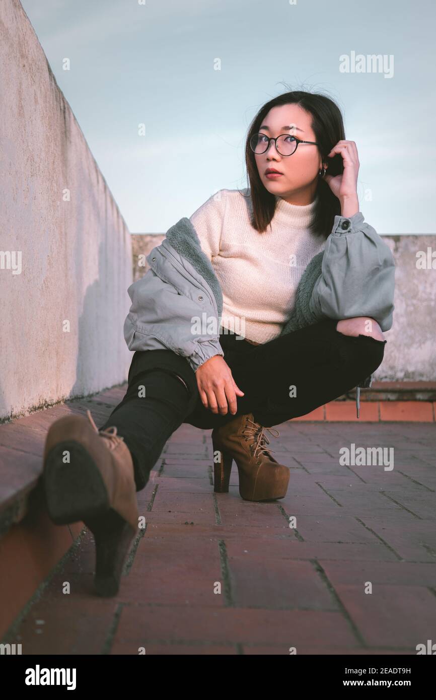 Asian woman in urban outfit on a rooftop Stock Photo - Alamy