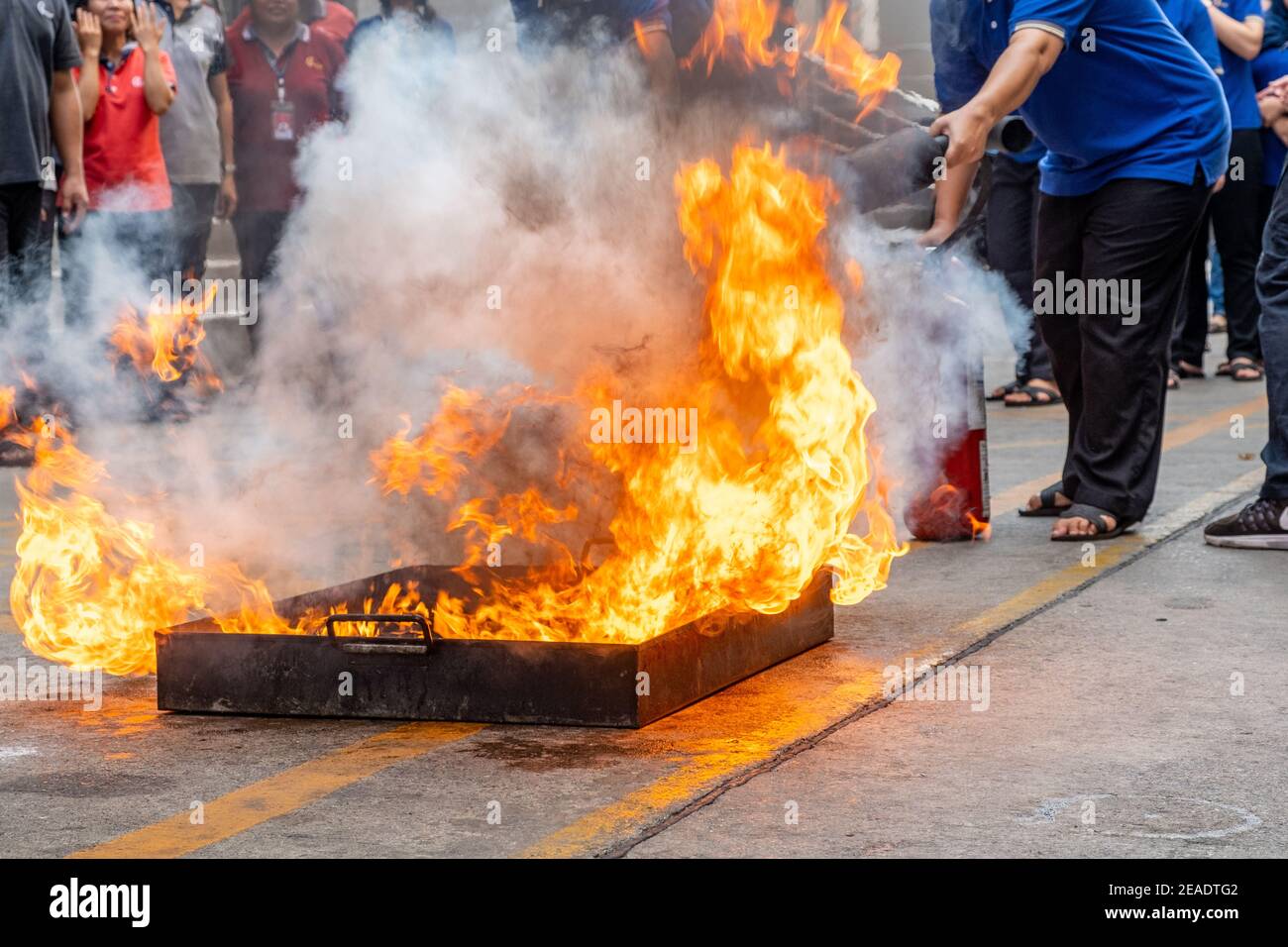 Employees firefighting training,Extinguish a fire Stock Photo - Alamy
