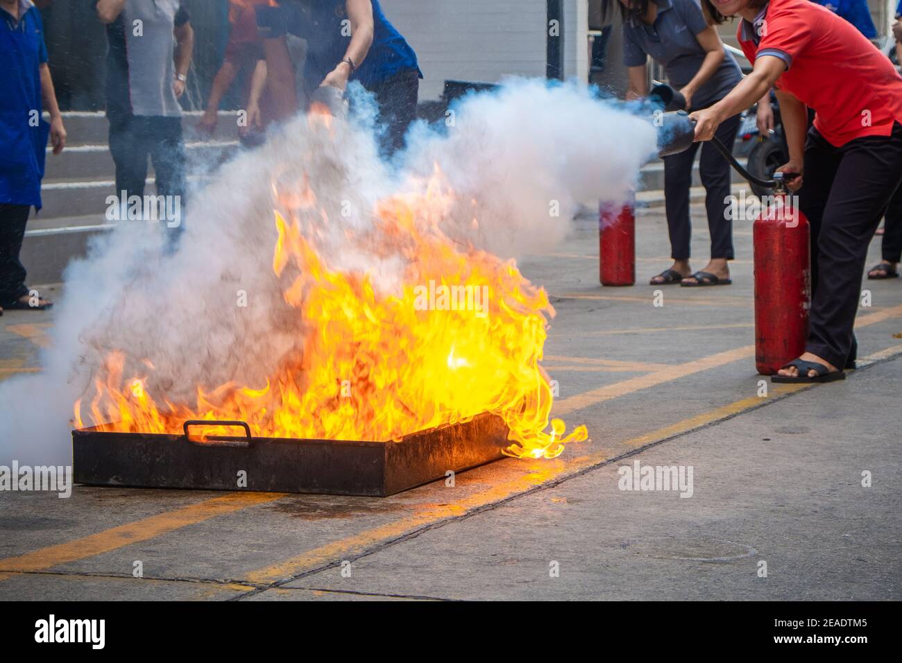 Employees firefighting training,Extinguish a fire Stock Photo - Alamy