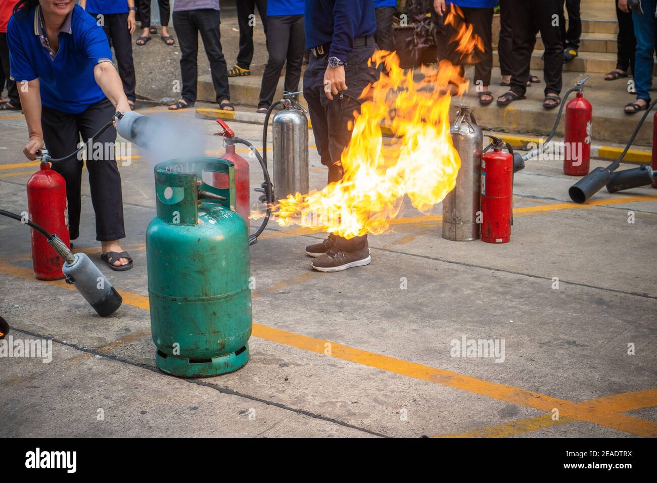 Employees firefighting training,Extinguish a fire Stock Photo - Alamy
