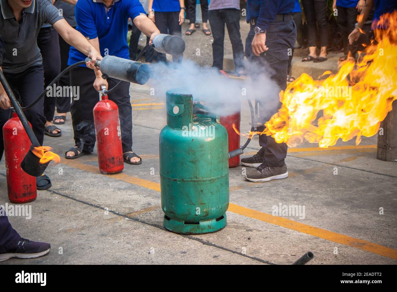 Employees firefighting training,Extinguish a fire Stock Photo - Alamy