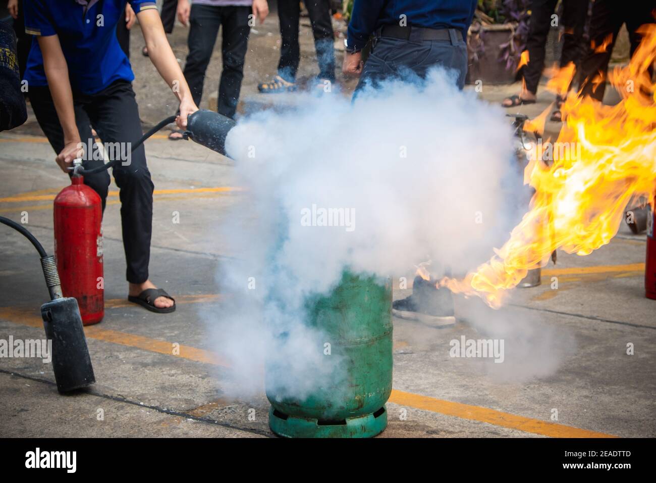Employees firefighting training,Extinguish a fire Stock Photo - Alamy