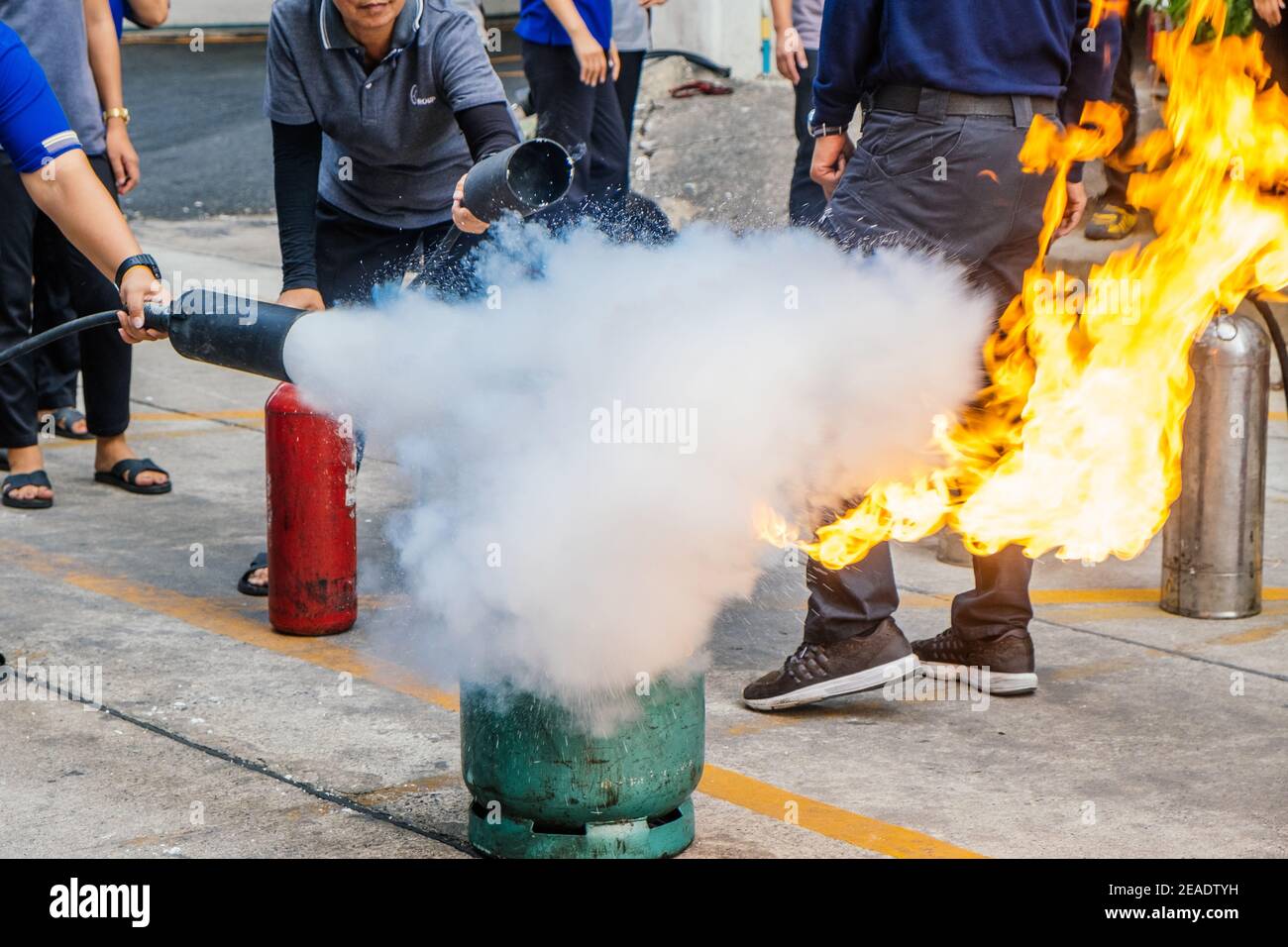 Employees firefighting training,Extinguish a fire Stock Photo - Alamy
