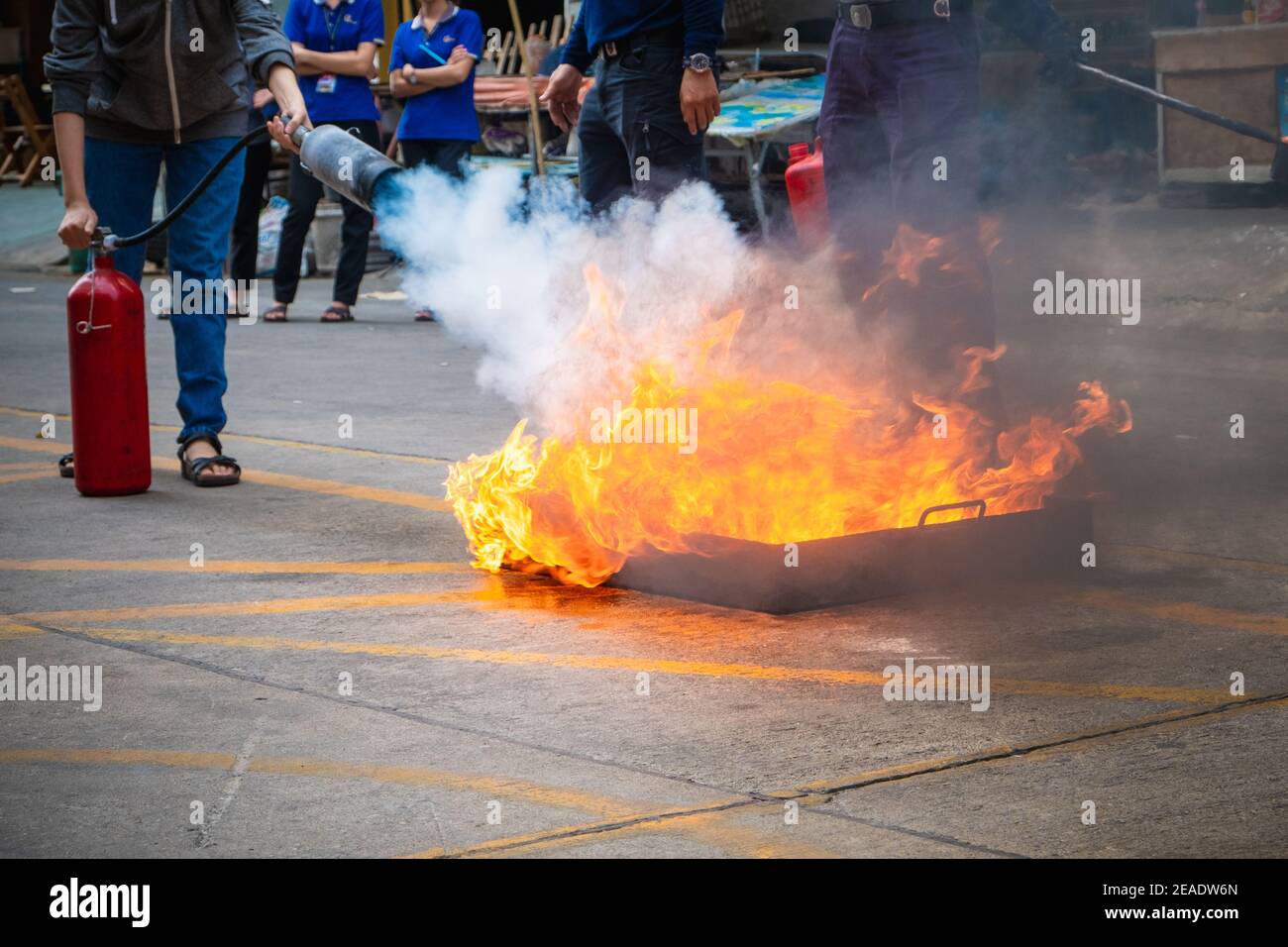 Employees firefighting training,Extinguish a fire Stock Photo - Alamy
