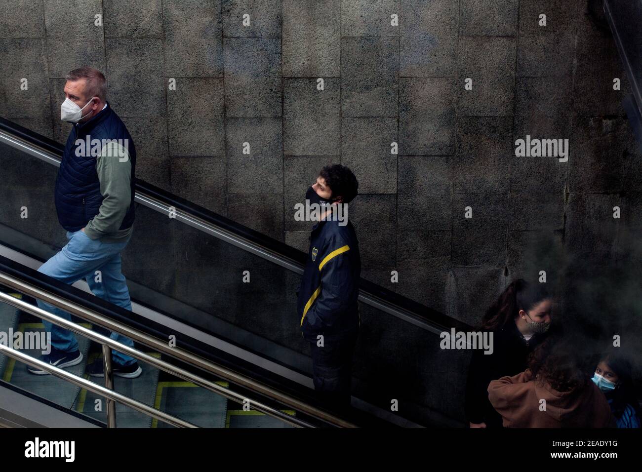 People exiting metro on mechanical escalator, Barcelona, Spain Stock ...