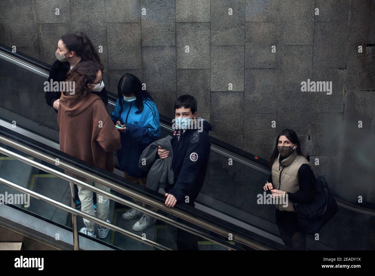 People exiting metro on mechanical escalator, Barcelona, Spain Stock ...