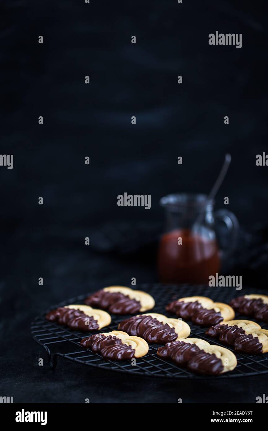 Homemade chocolate dipped shortbread cookies on dark background Stock ...