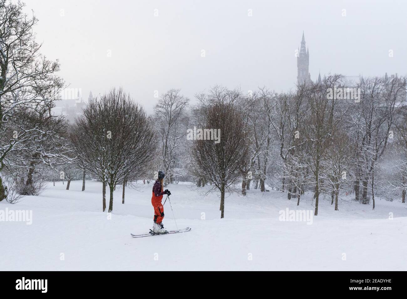 People enjoying winter snow in Kelvingrove Park Glasgow UK. Children on ...