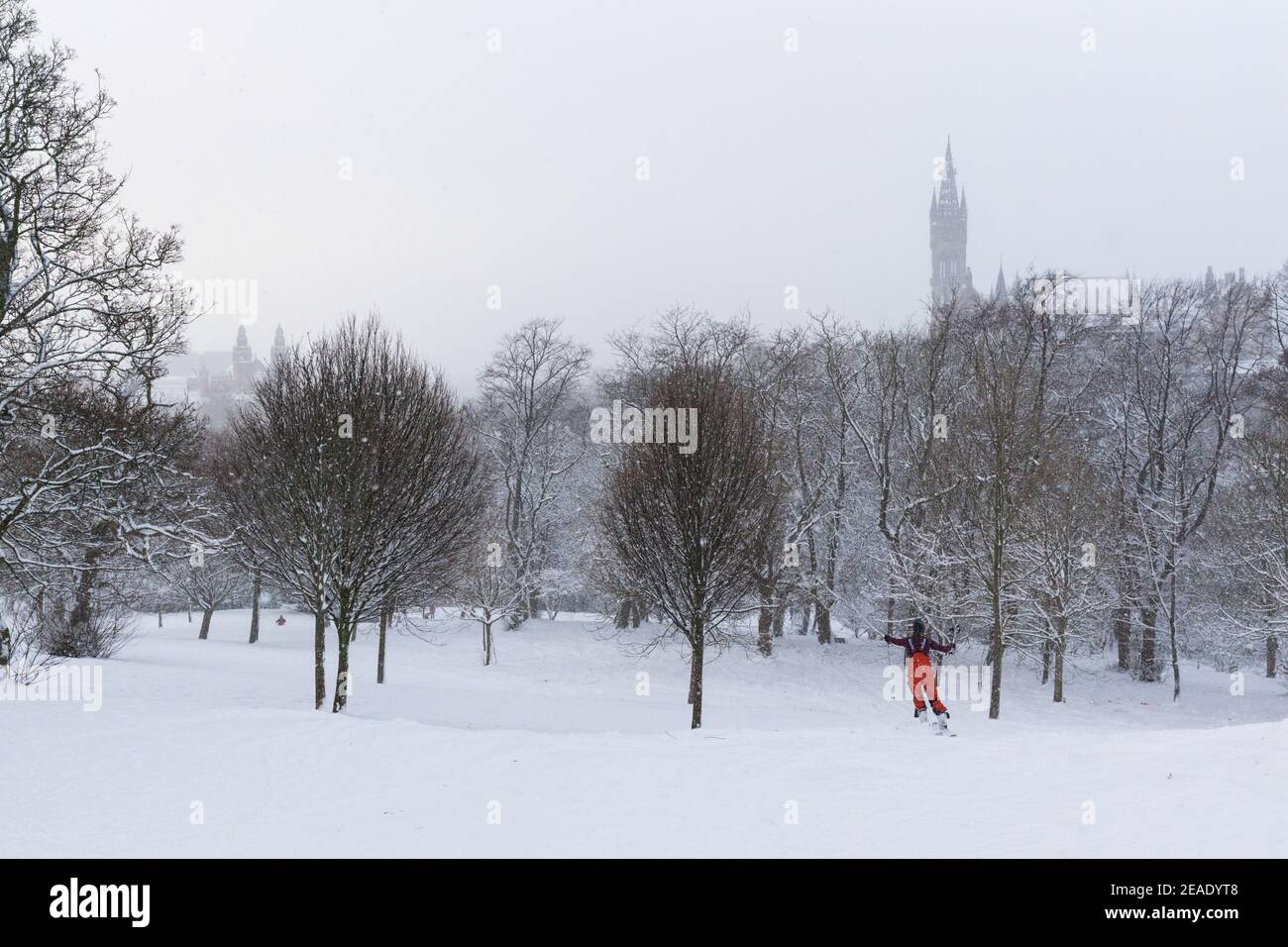 People enjoying winter snow in Kelvingrove Park Glasgow UK. Children on ...
