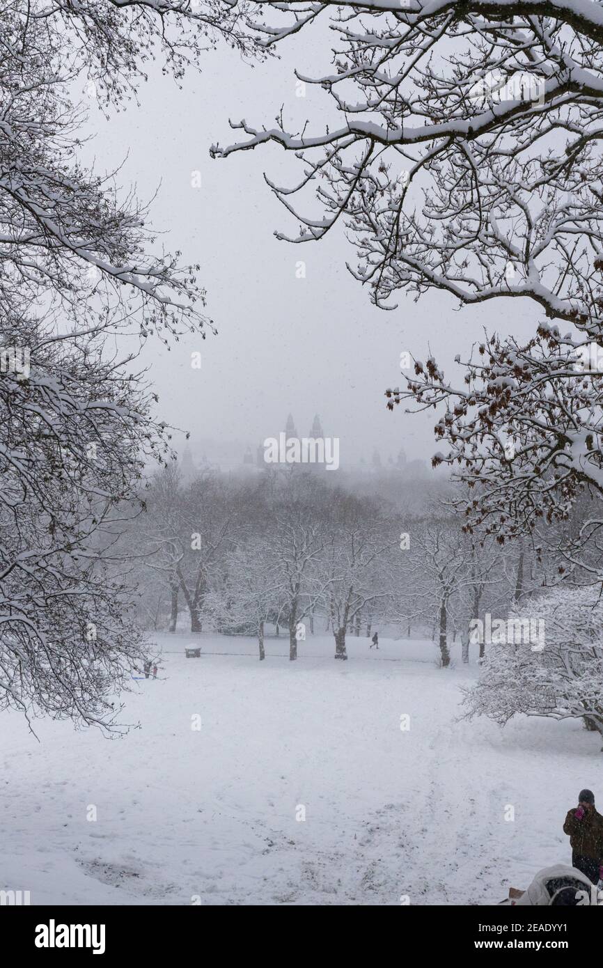 People enjoying winter snow in Kelvingrove Park Glasgow UK. Children on ...