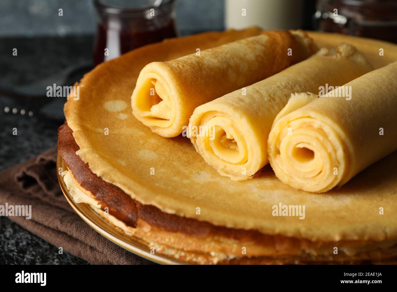 Concept of breakfast with crepes rolls on black smokey table Stock ...