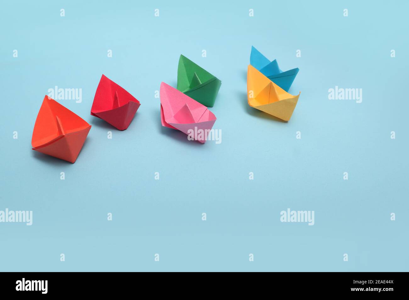 Colorful paper ships on white background, Leadership and Business ...