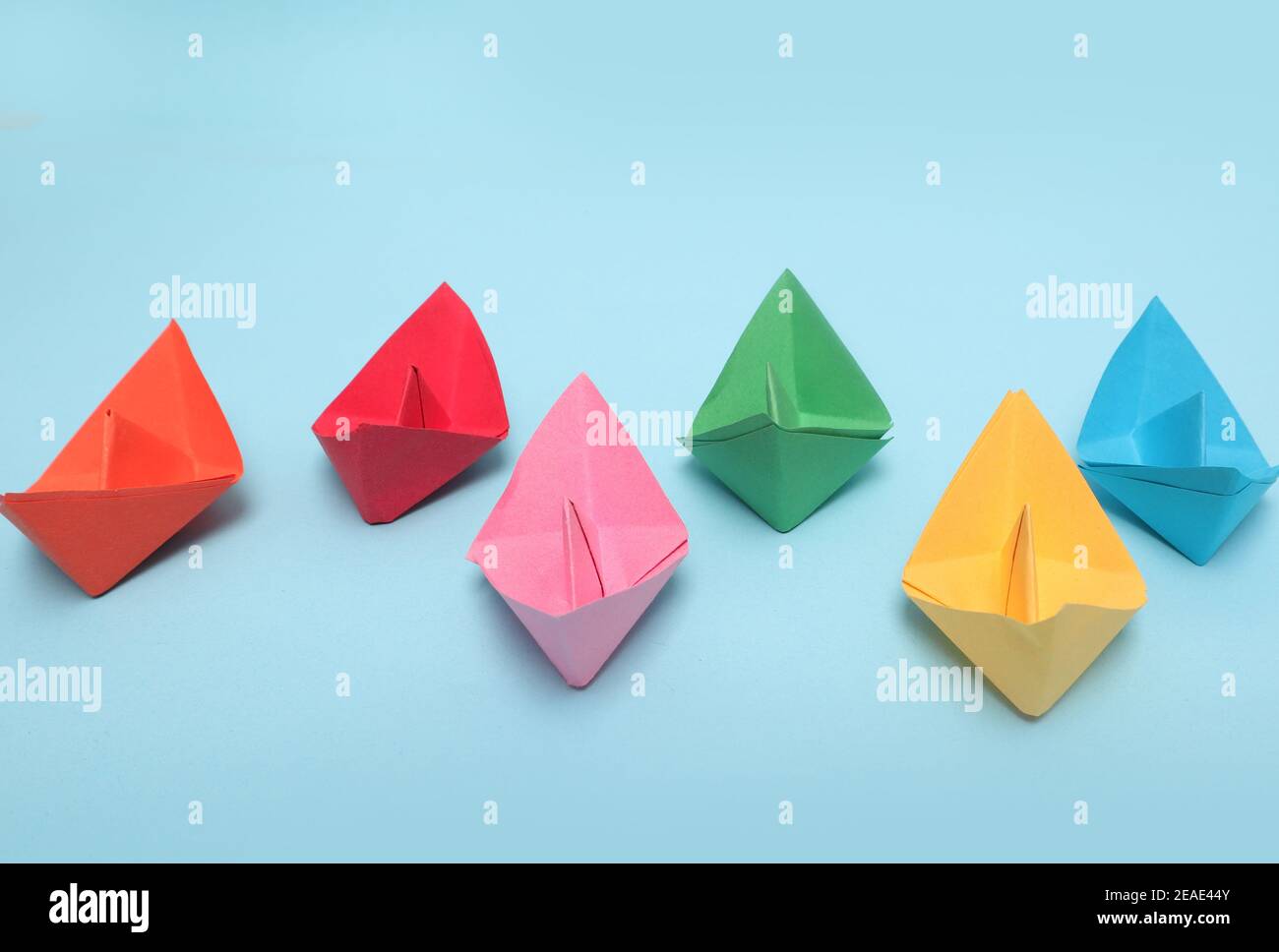 Colorful paper ships on white background, Leadership and Business ...