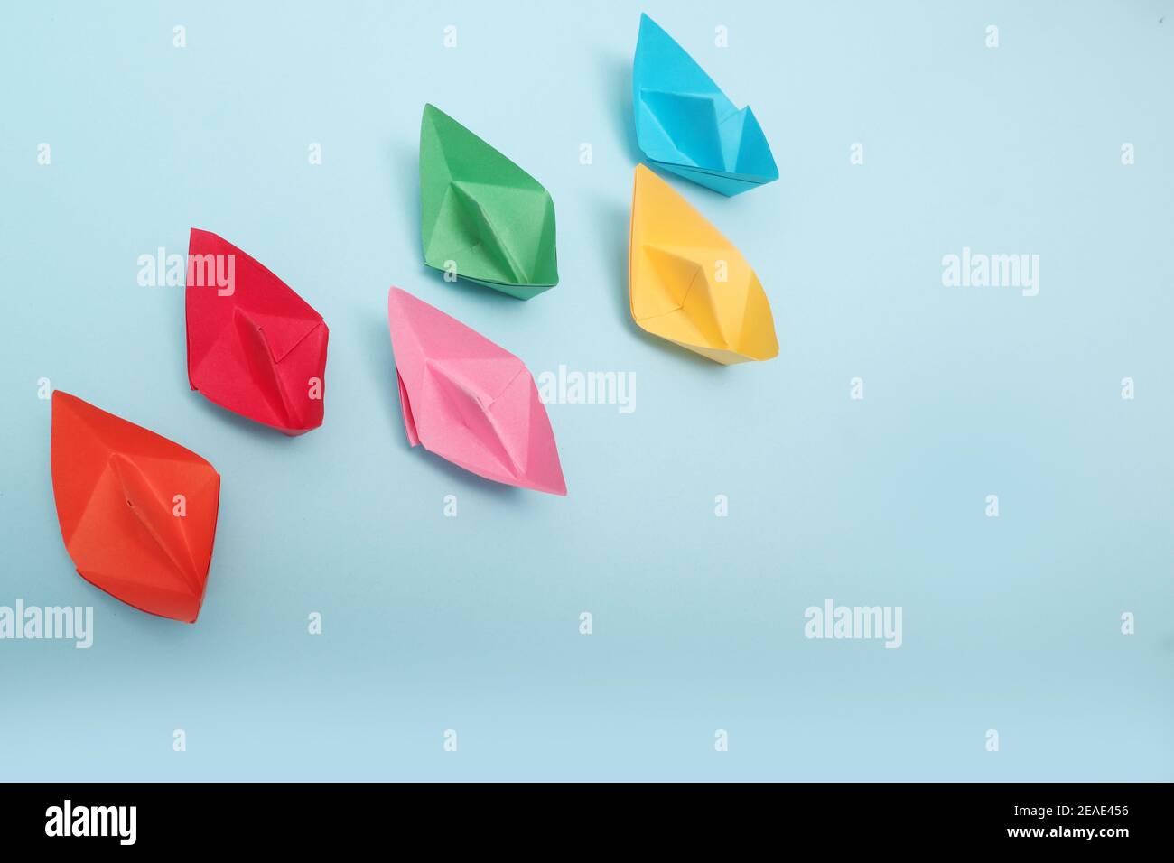 Colorful paper ships on white background, Leadership and Business ...