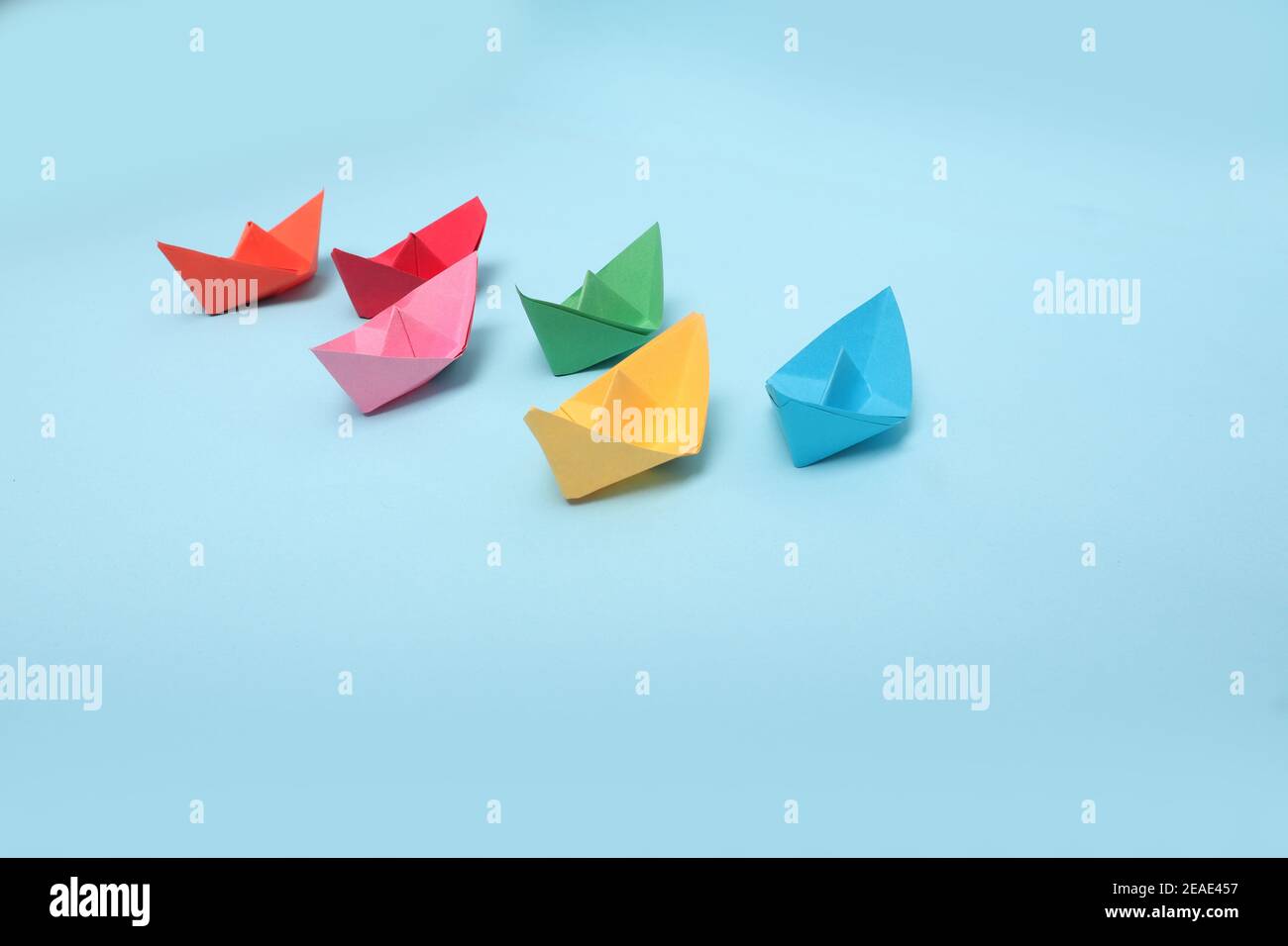 Colorful paper ships on white background, Leadership and Business ...