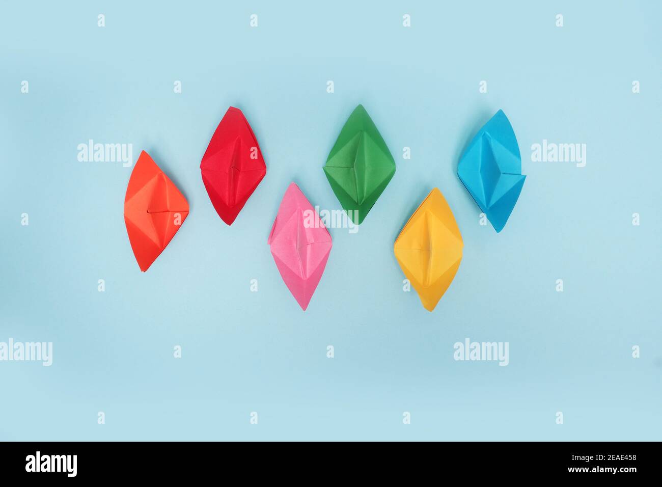 Colorful paper ships on white background, Leadership and Business ...