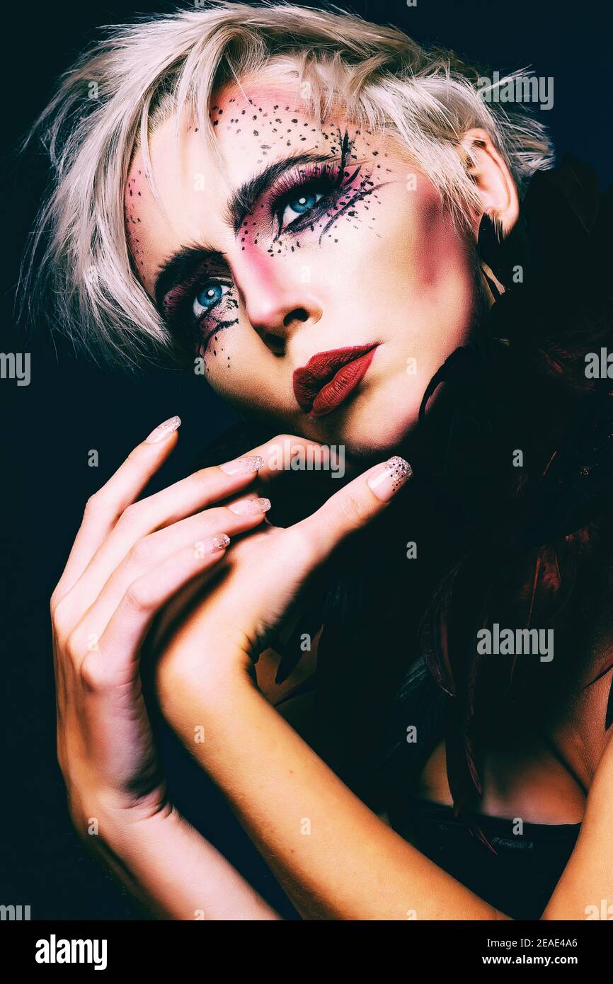 Female Caucasian model with avant-garde look, beautiful striking makeup ...