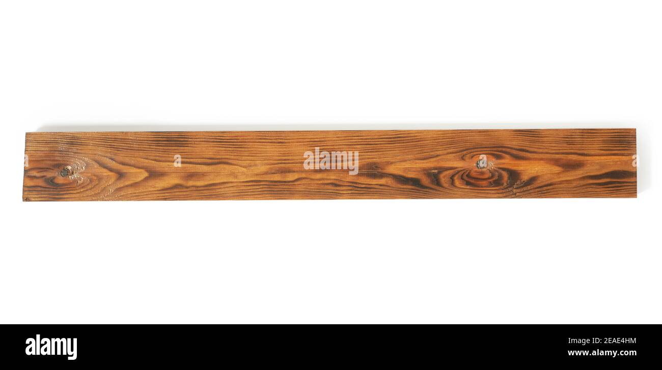 Wooden plank burn and covered with brown stain isolated on white ...