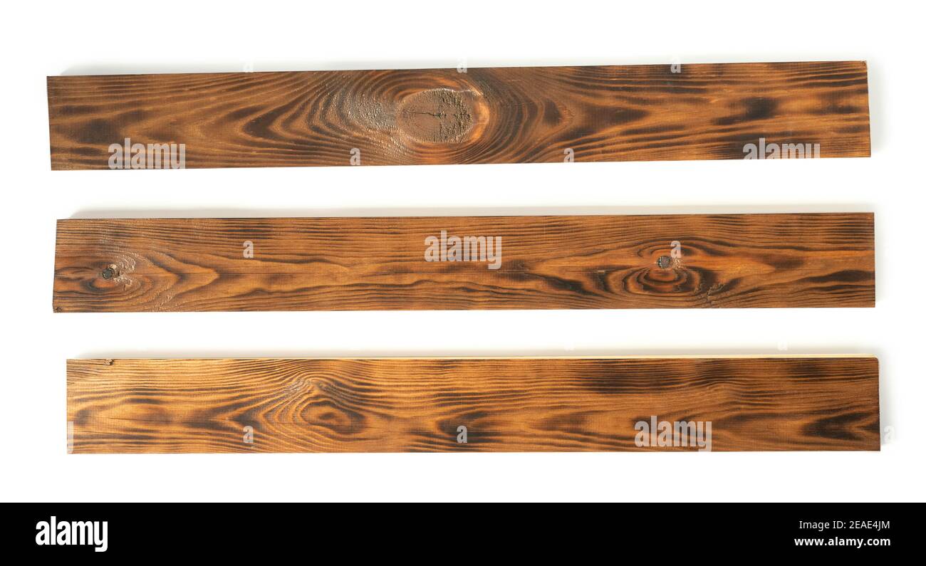 Wooden plank burn and covered with brown stain isolated on white ...