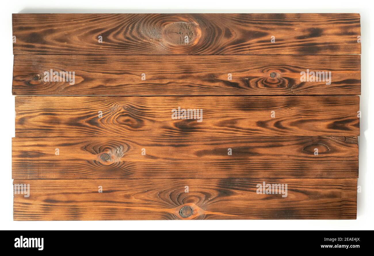 Wooden plank burn and covered with brown stain isolated on white ...