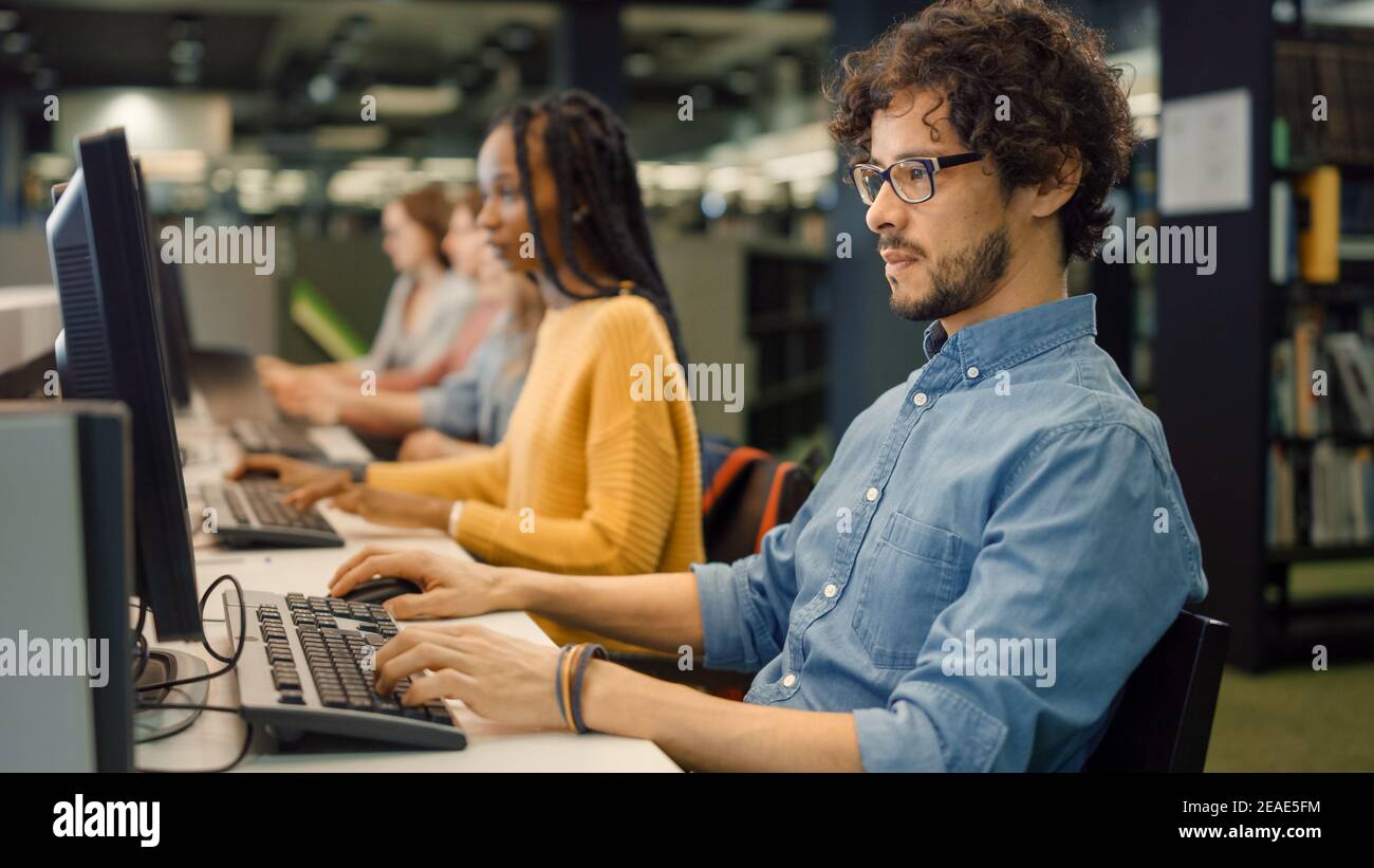 University Library: Handsome Bright Boy using Computer for Class ...