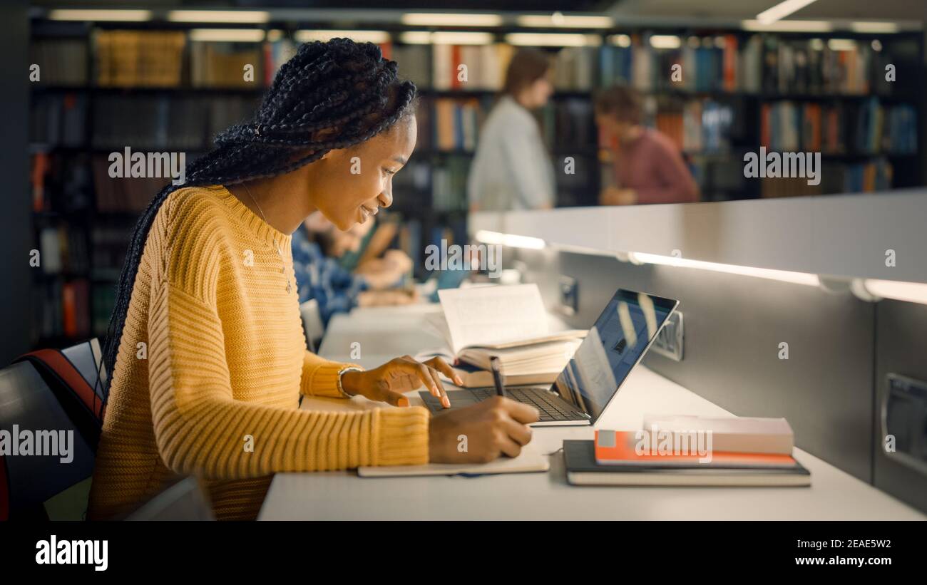 University Library: Gifted Beautiful Black Girl Sitting at the Desk ...