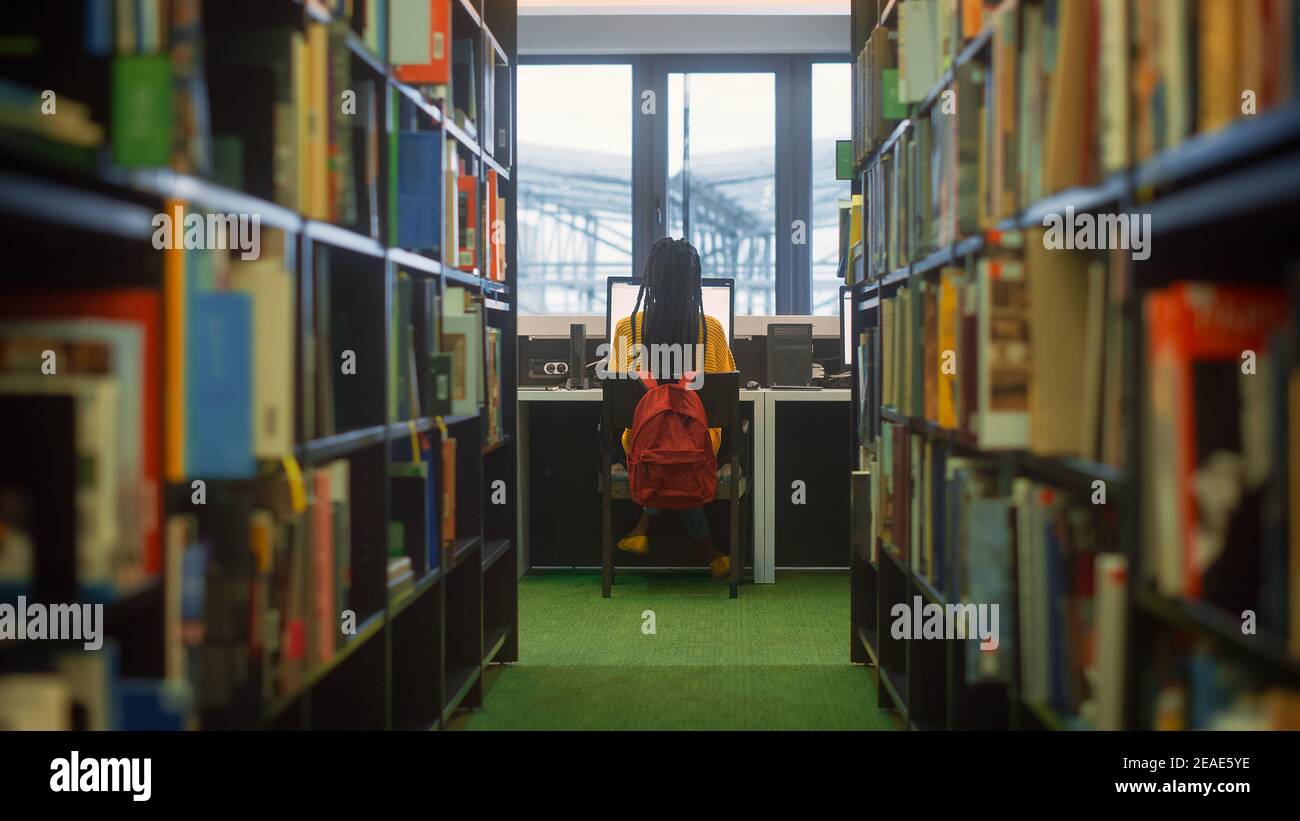 University Library: Focused Bright Student Working on Personal Computer ...