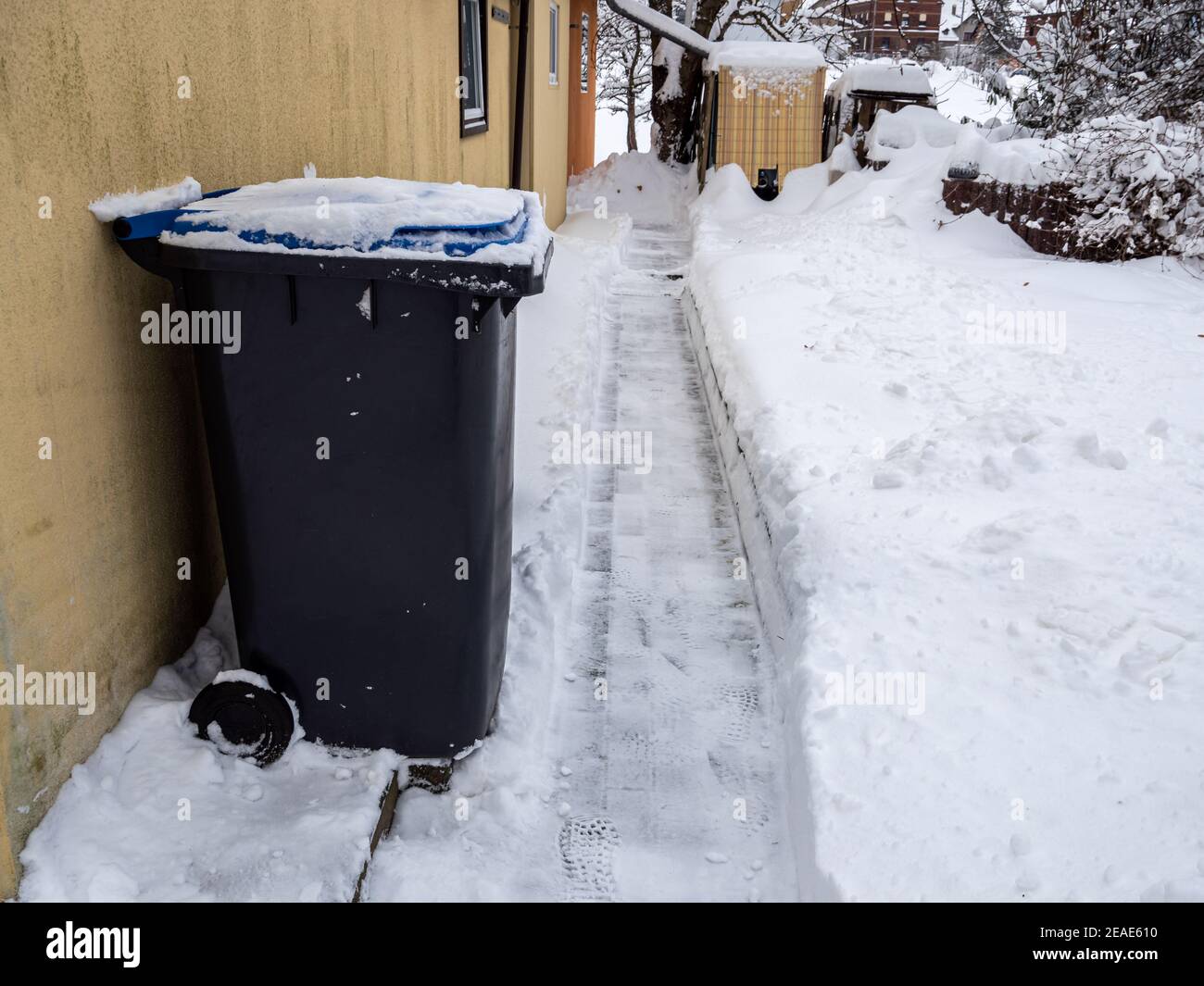 Clear snow away from the garbage cans Stock Photo - Alamy