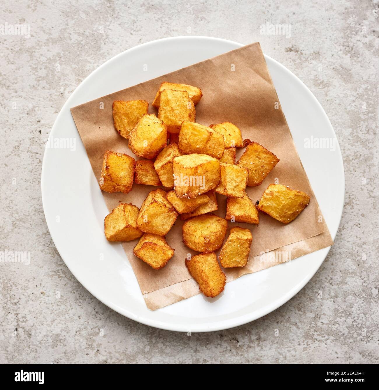 portion of fried potatoes on white restaurant plate, top view Stock ...