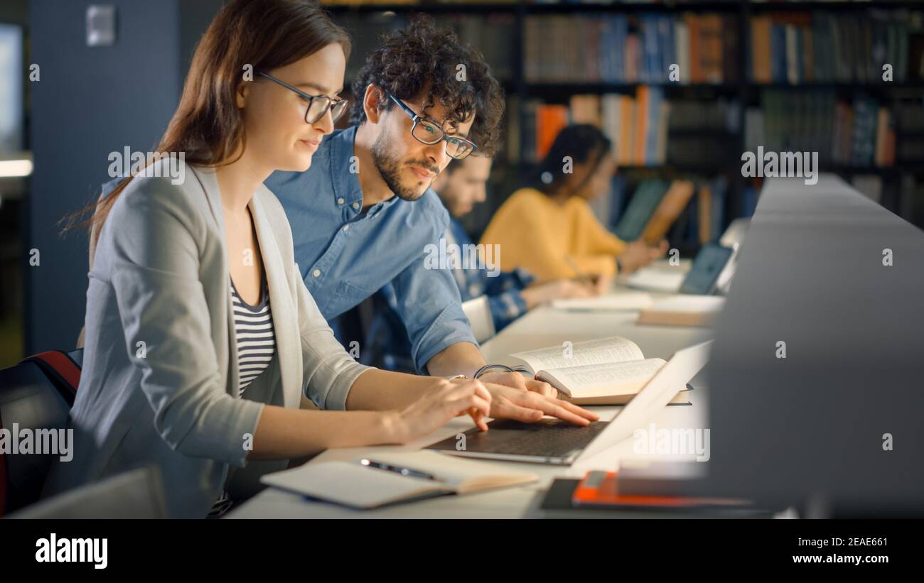 University Library: Talented Caucasian Girl uses Laptop, Smart Helpful ...