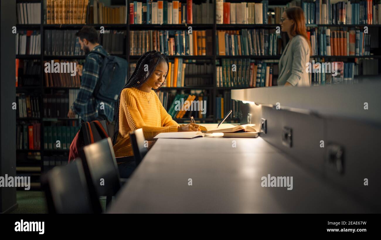 University Library: Gifted Black Girl uses Laptop, Writes Notes for the ...