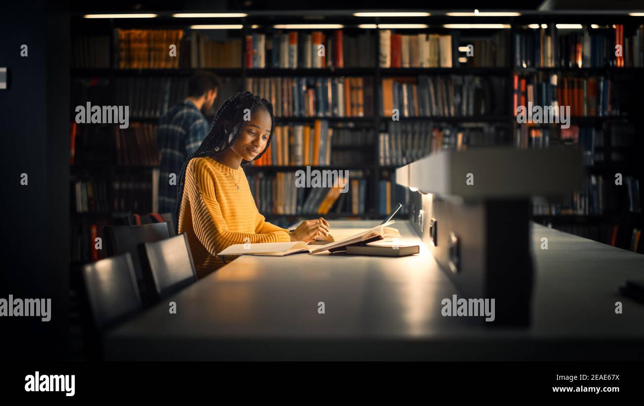 University Library: Gifted Black Girl uses Laptop, Writes Notes for the ...