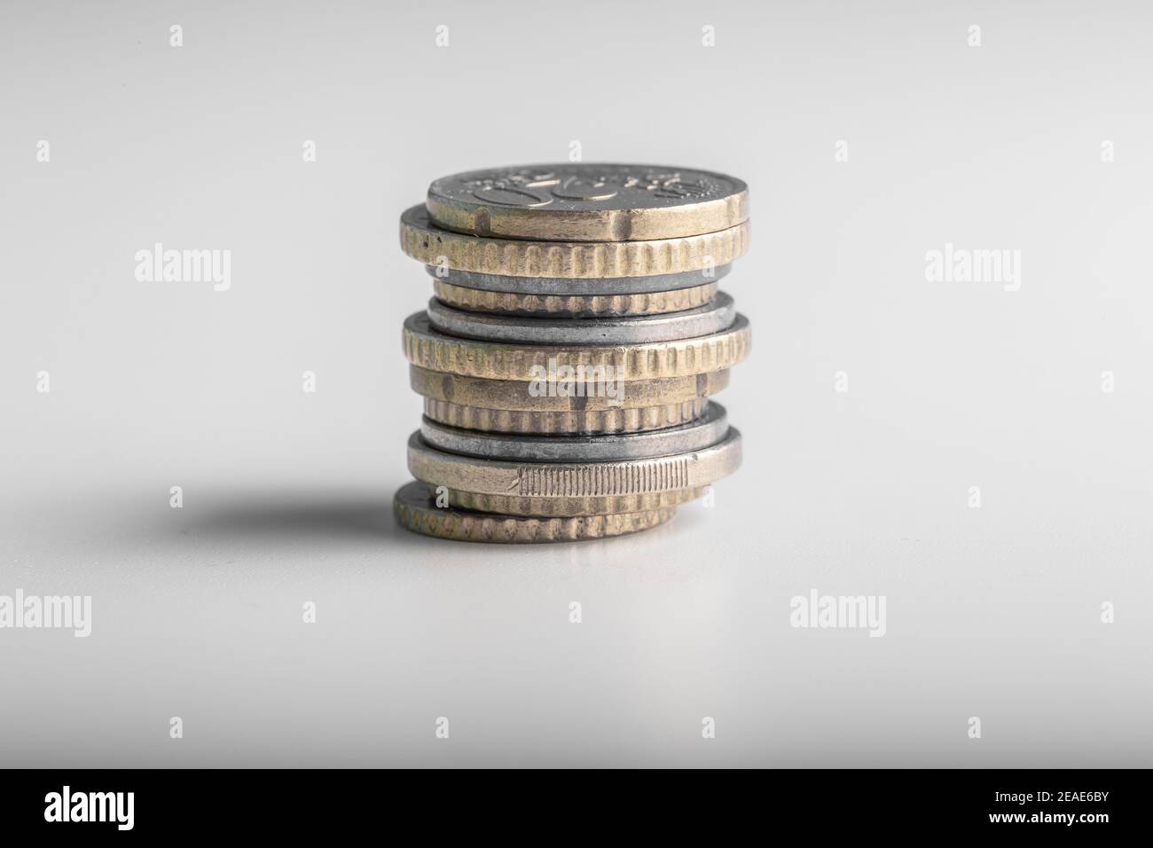 Coins cash money in piles, Isolated on white background Stock Photo - Alamy