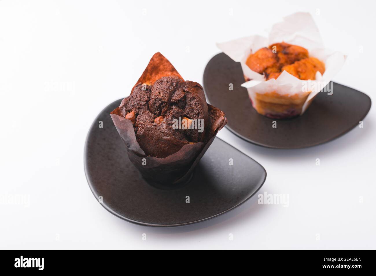 Photo of two muffins over white background Stock Photo - Alamy