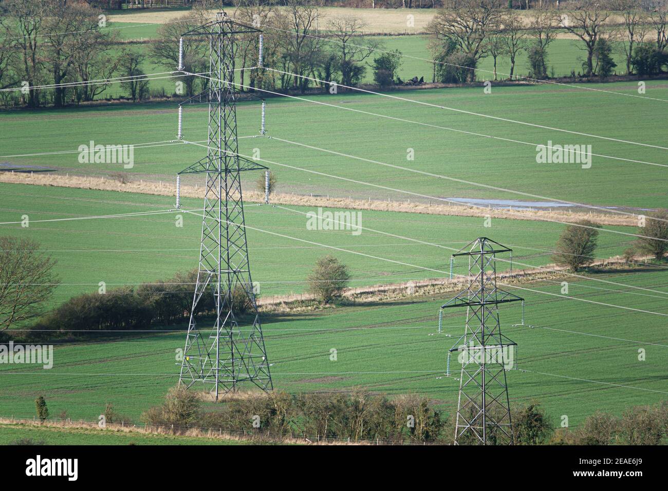 power pylons with drooping cables straddle green fields in Pewsey Vale ...
