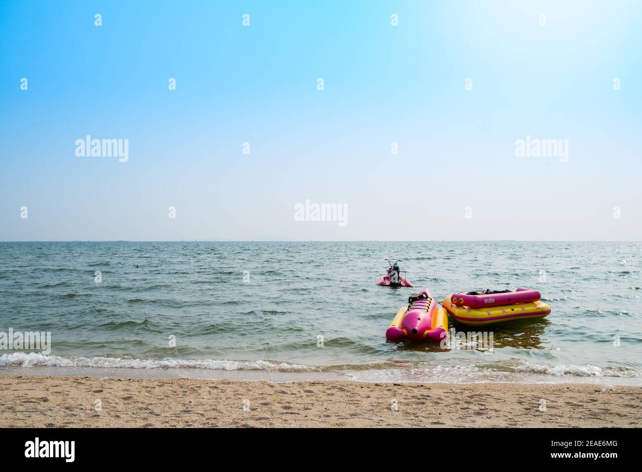 Banana boat and a rubber boat float with jet ski in the sea with blue ...