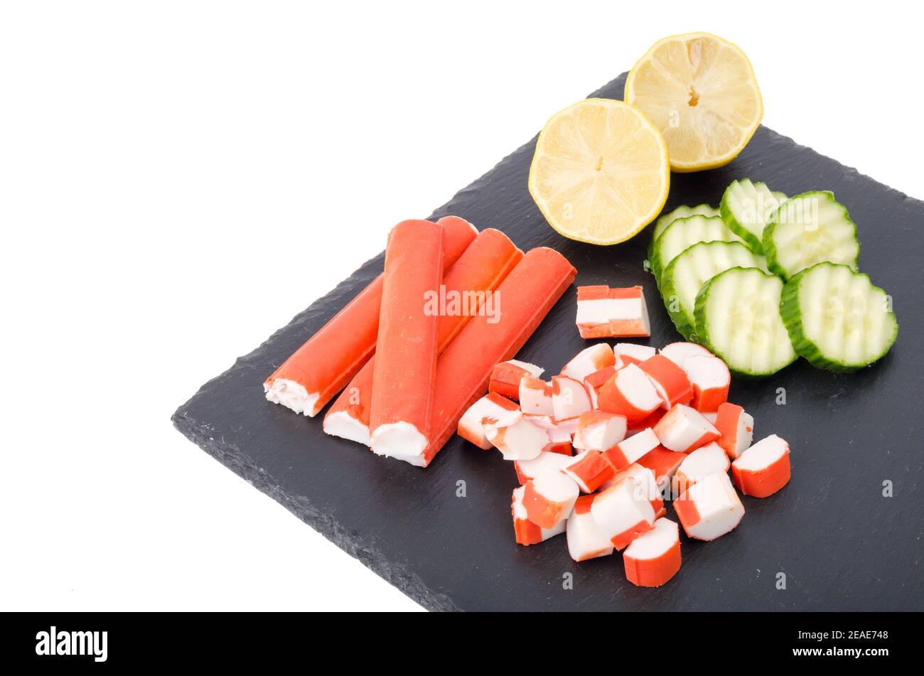 Surimi, crab sticks, slices of fresh green cucumber. Studio Photo Stock ...